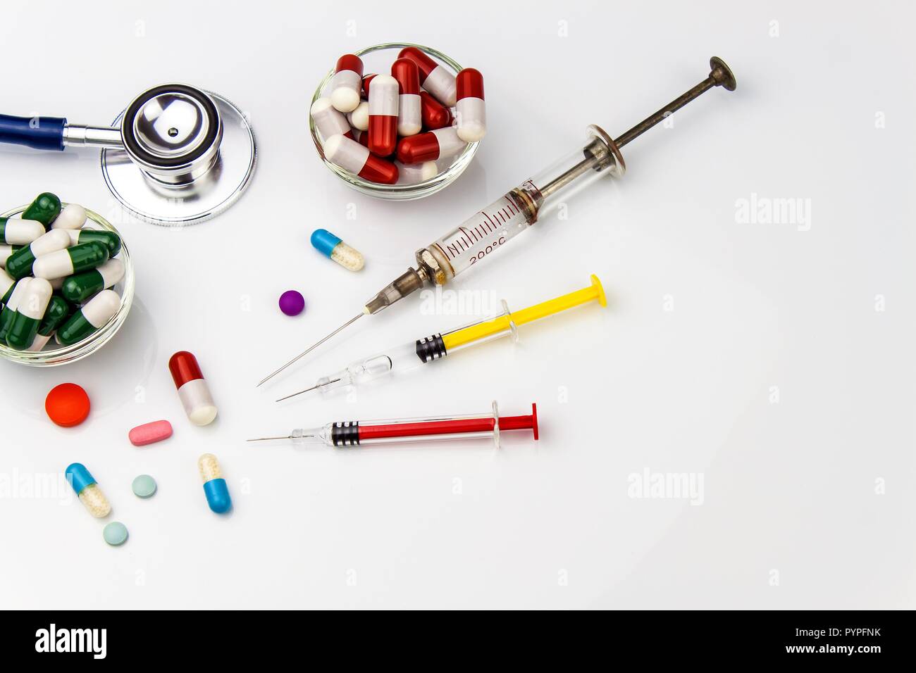 Assorted medical drugs and syringe on white background. Injection for ...