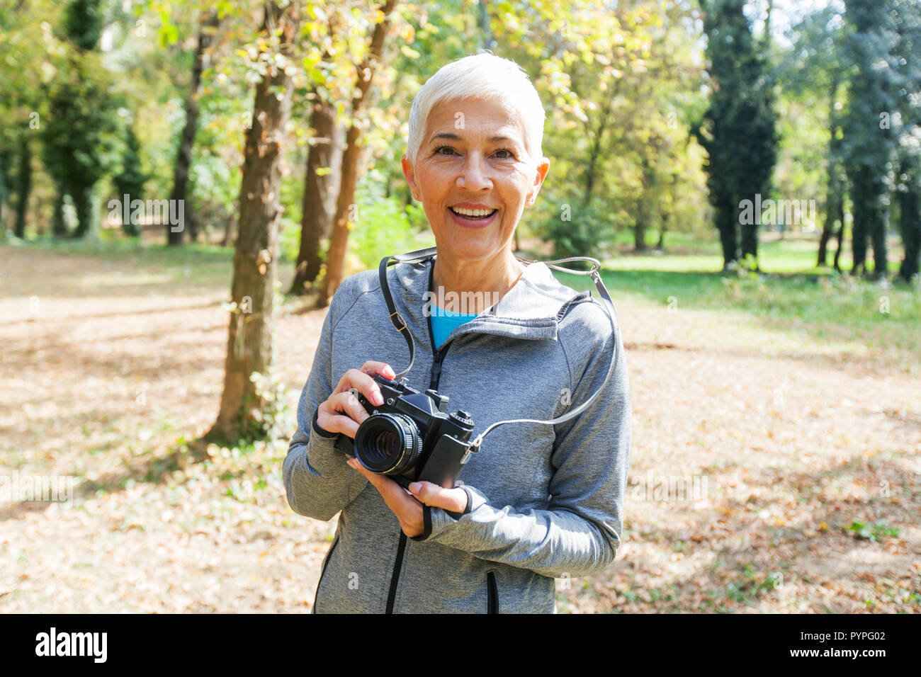 Senior female amateur photographer taking hi-res stock photography and ...