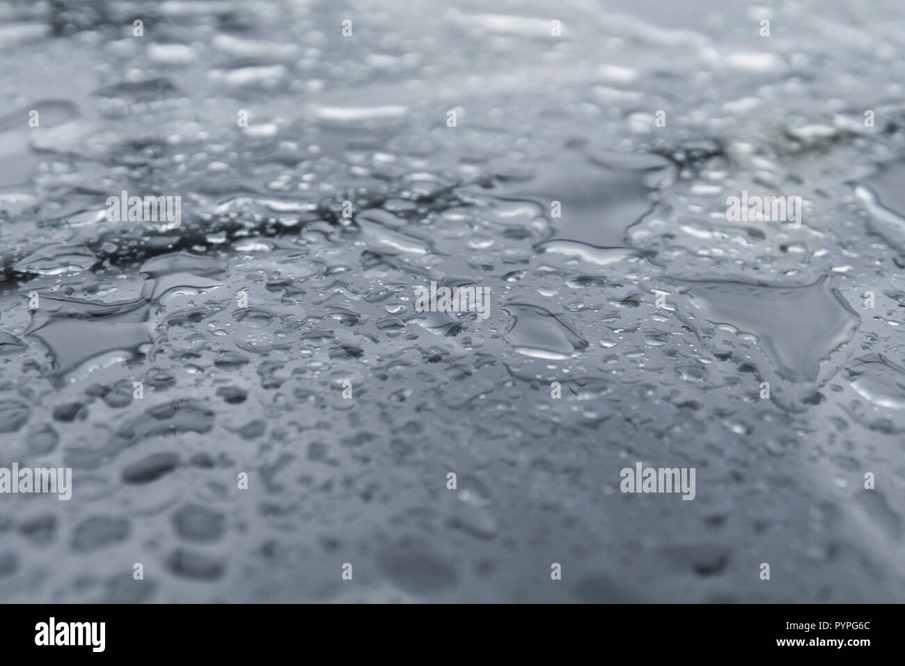 Natural water drops on a glass table after rain Stock Photo - Alamy