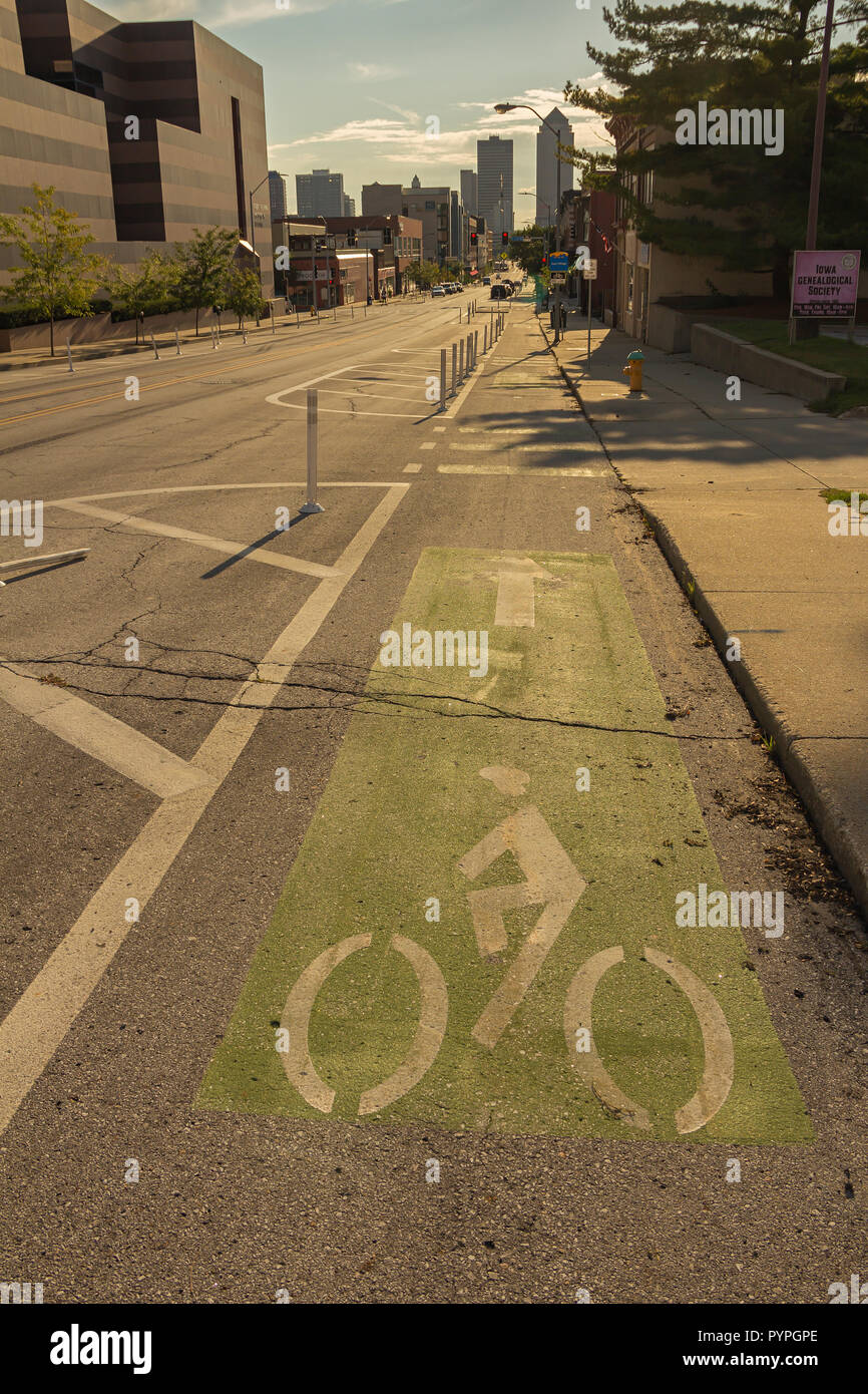 Green sign of a bicycle path drawn on the asphalt road. Lanes for ...