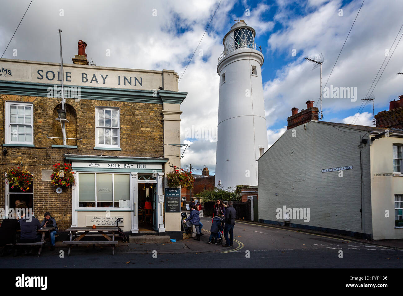 Southwold's iconic lighthouse seen behind The Sole Bay Inn pub in ...