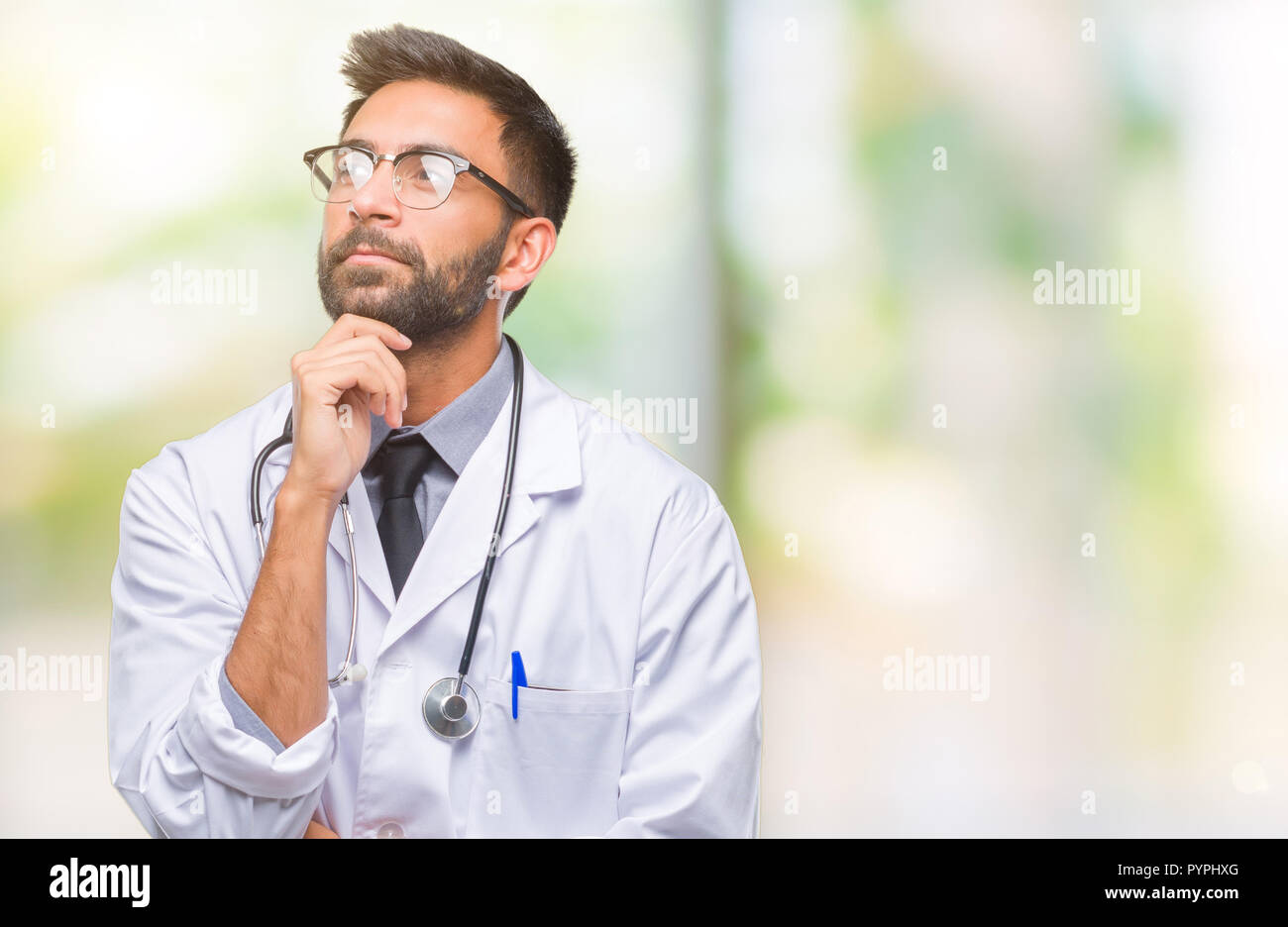 Adult hispanic doctor man over isolated background with hand on chin ...