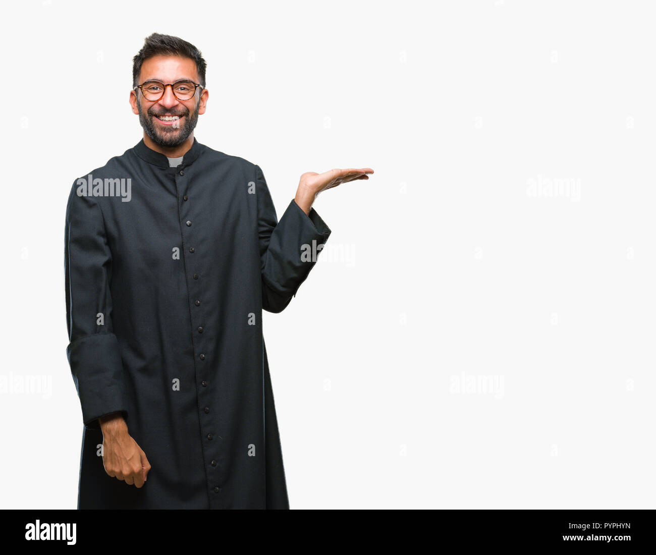 Adult hispanic catholic priest man over isolated background smiling ...
