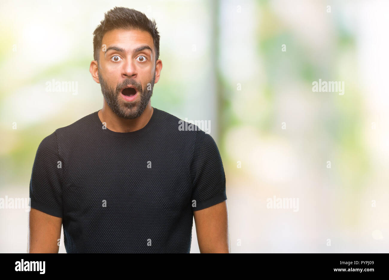 Adult hispanic man over isolated background afraid and shocked with ...