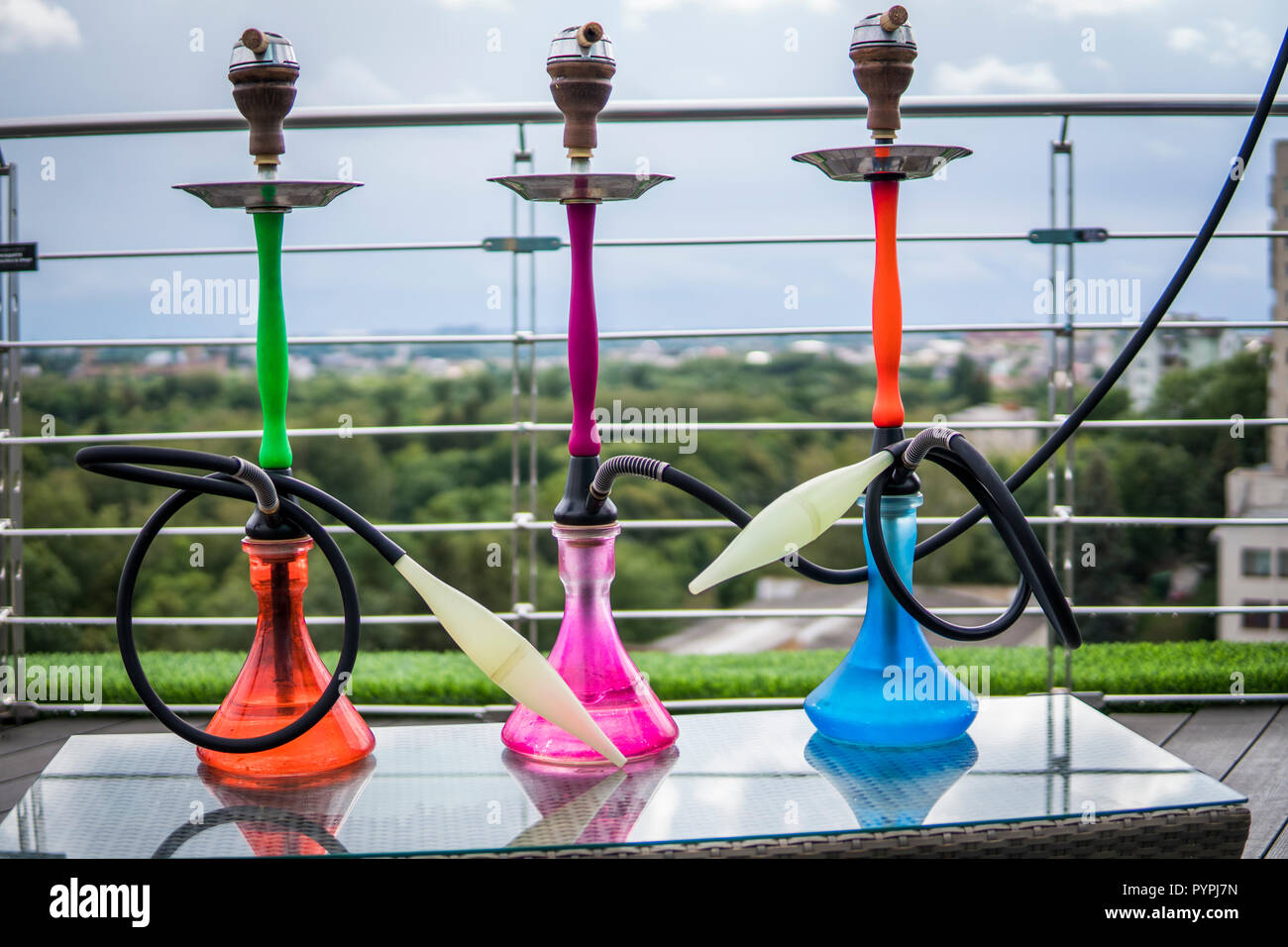 Three colors hookahs on table in hookah lounge in a day Stock Photo - Alamy