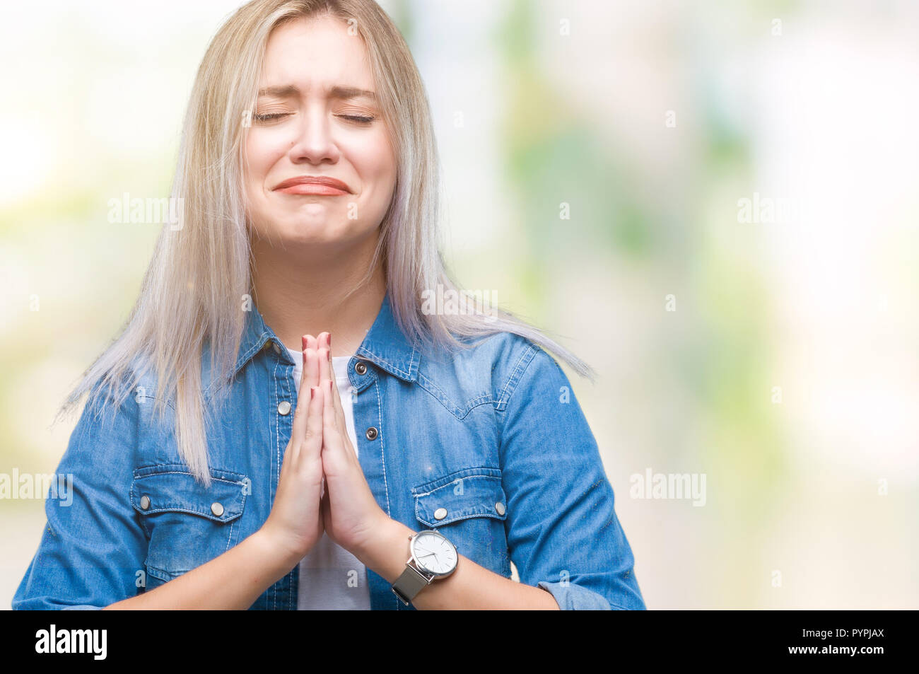 Young blonde woman over isolated background begging and praying with ...