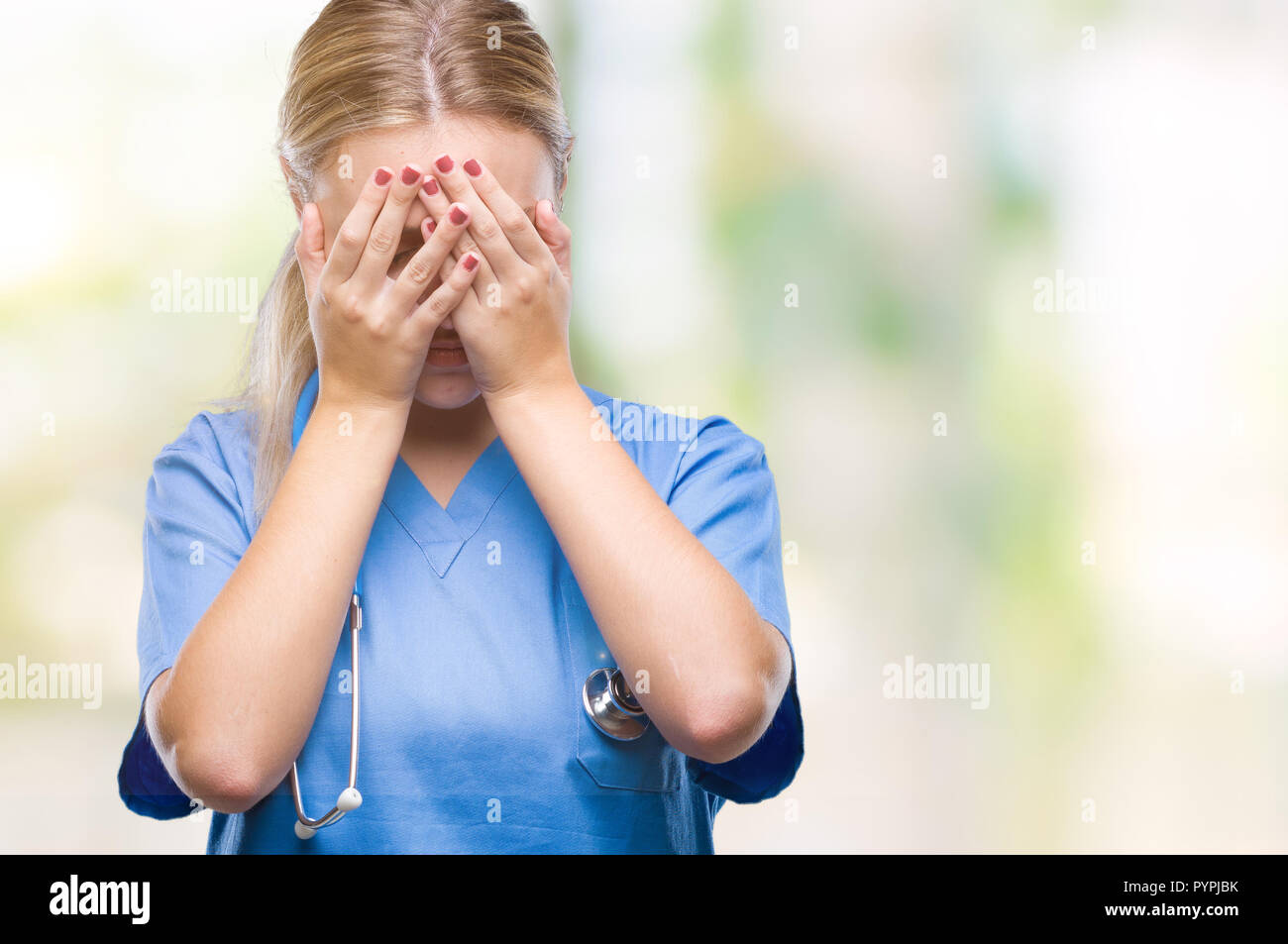 Young blonde surgeon doctor woman over isolated background with sad ...