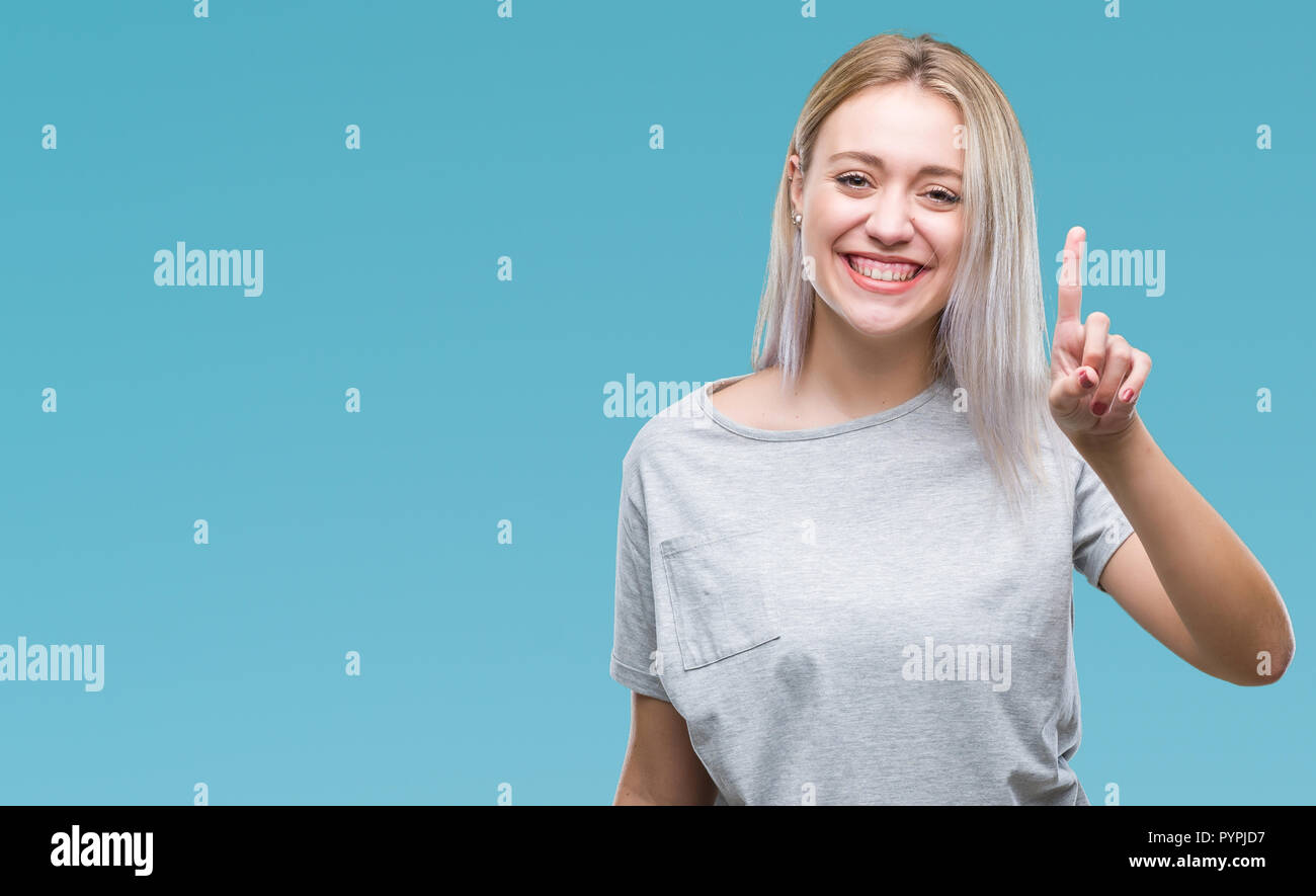 Young blonde woman over isolated background showing and pointing up ...