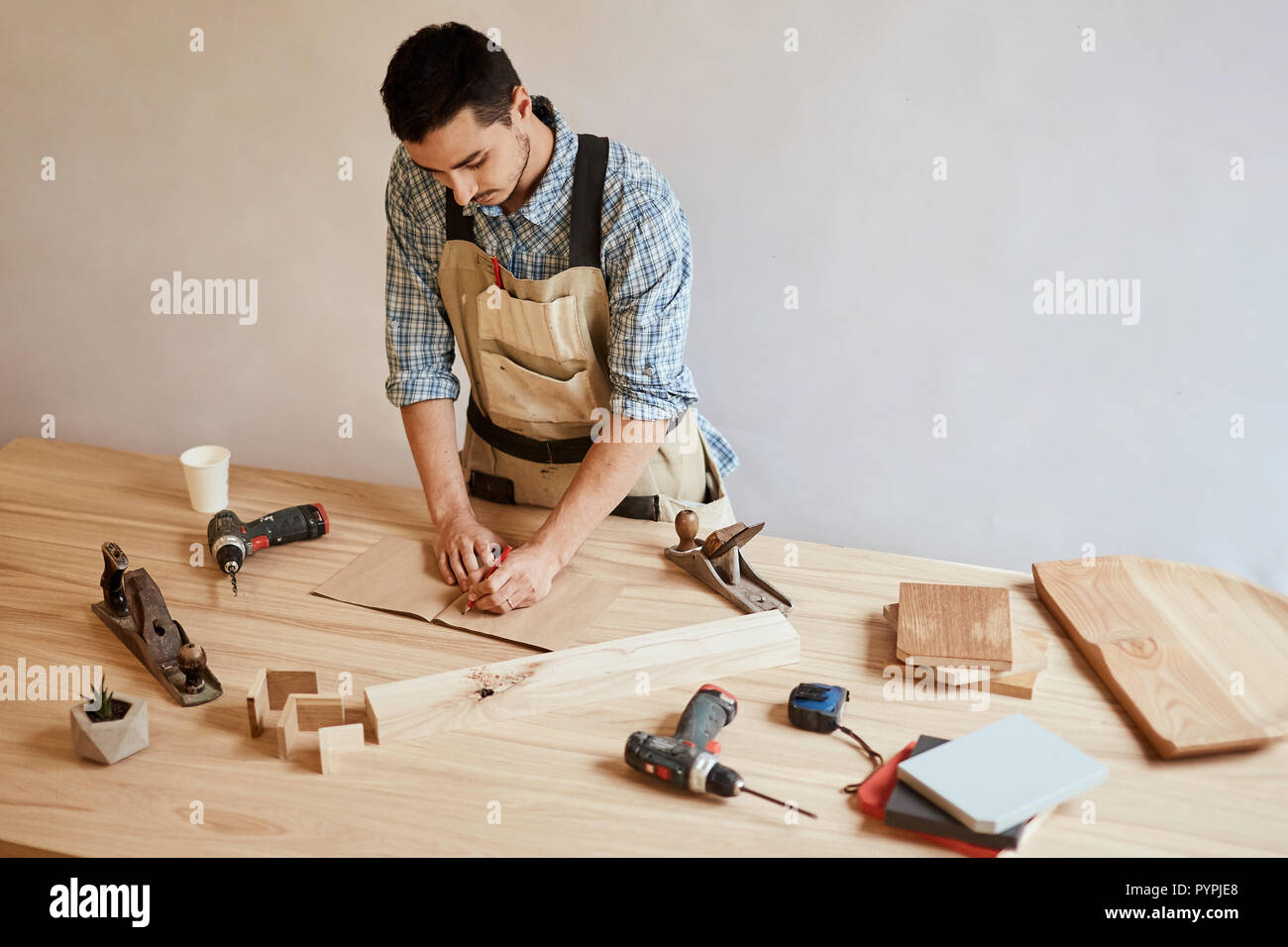 Man making draft plan using pencil on the table with tools Stock Photo ...