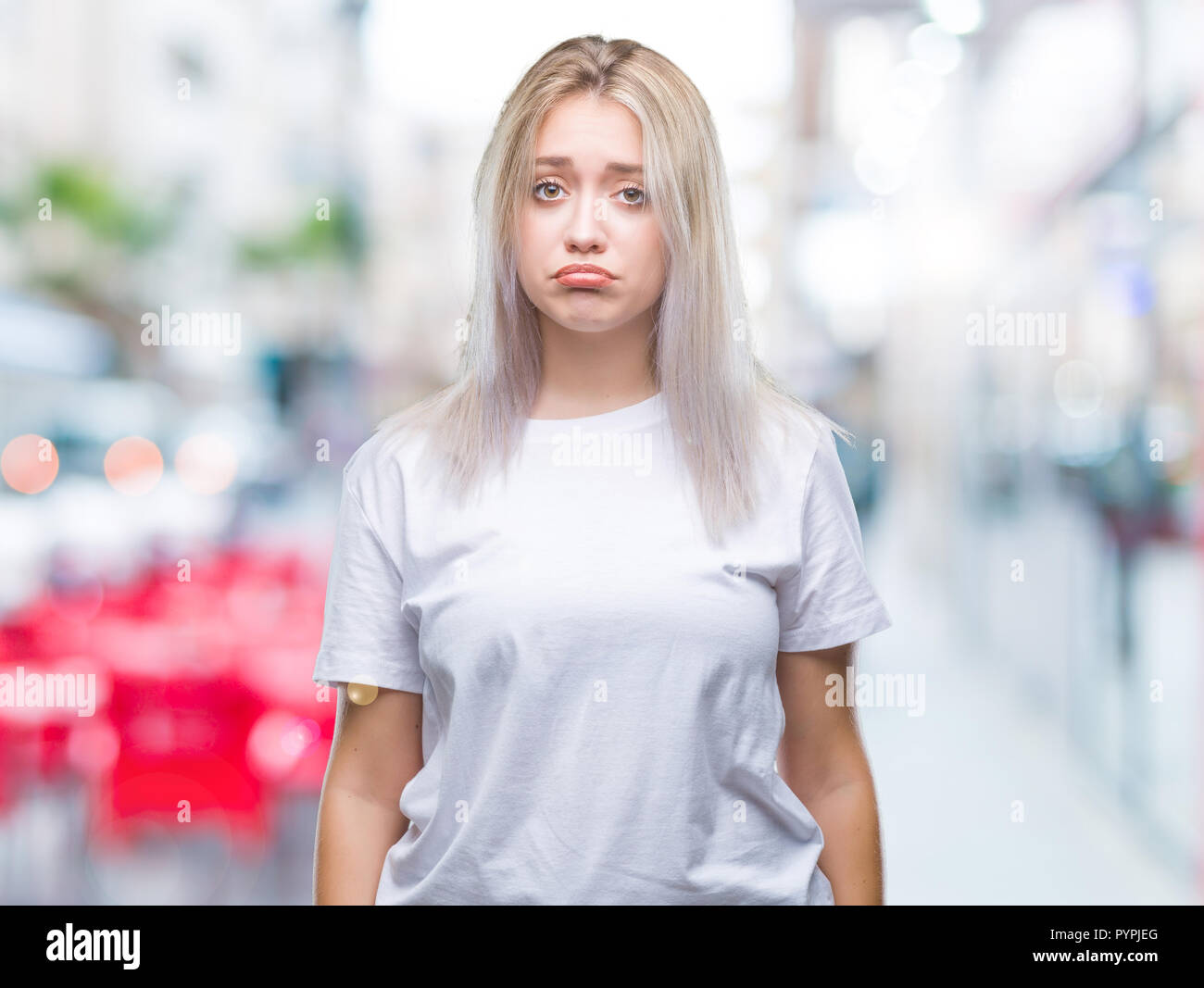 Young blonde woman over isolated background depressed and worry for ...