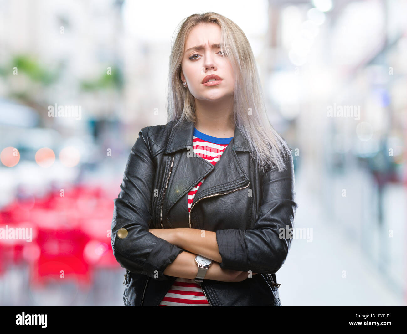 Young blonde woman wearing black jacket over isolated background ...