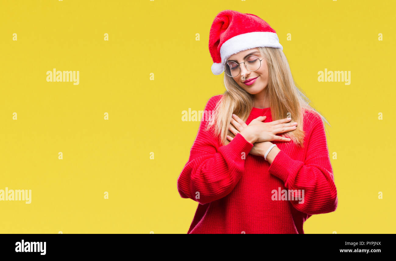 Young Beautiful Blonde Woman Wearing Christmas Hat Over Isolated