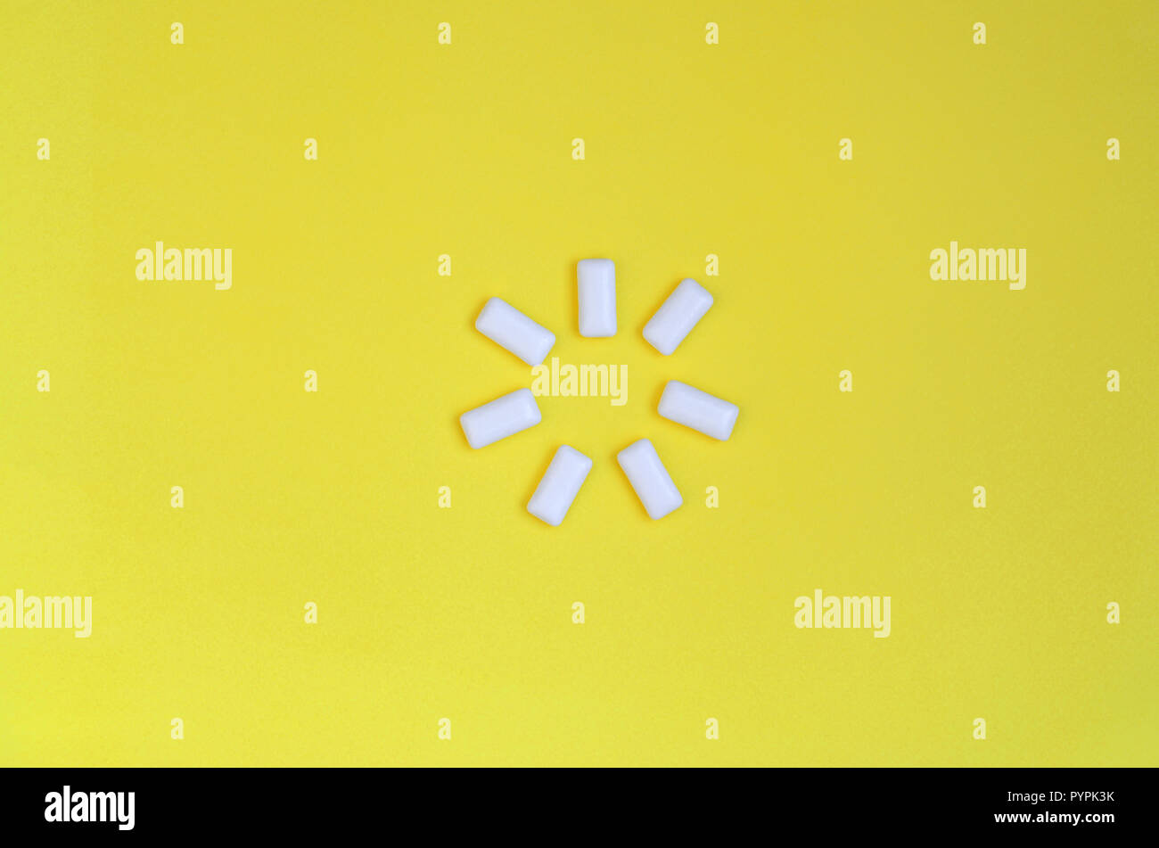 A few chewing gums lie on texture background of fashion pastel yellow ...