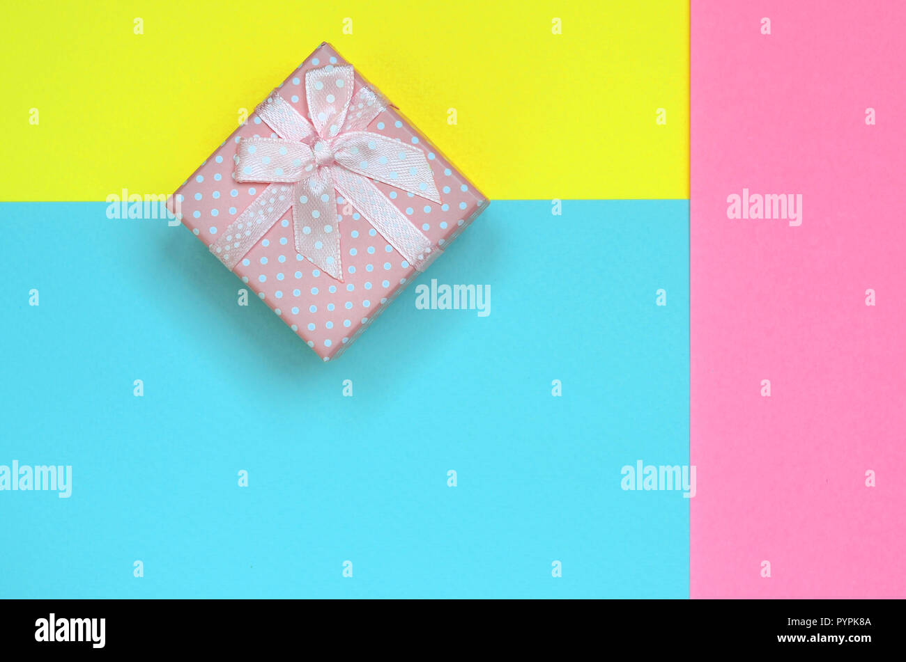 Small pink gift box lie on texture background of fashion pastel blue ...