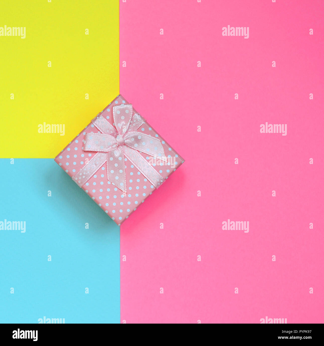 Small pink gift box lie on texture background of fashion pastel blue ...