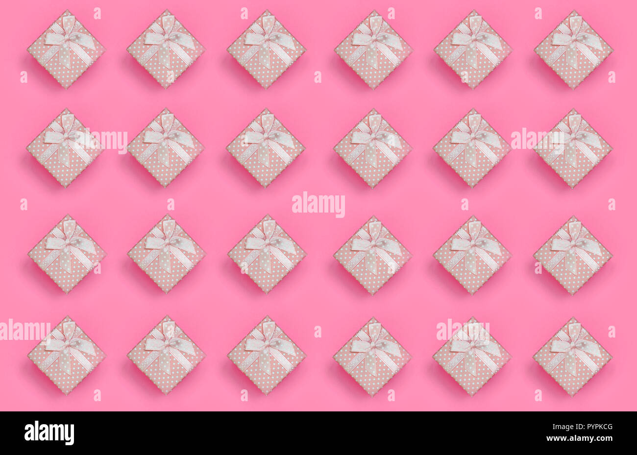 A lot of pink gift boxes lies on texture background of fashion pastel ...