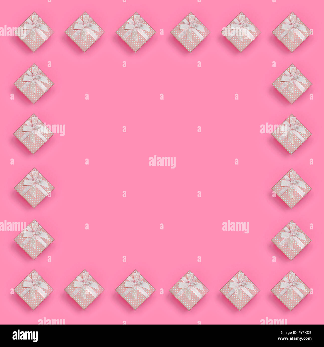 Frame of pink gift boxes lies on texture background of fashion pastel ...