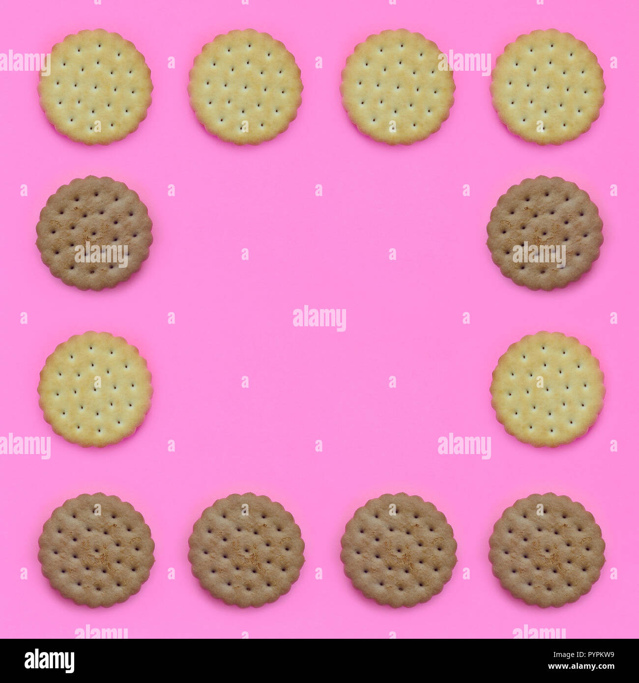 Frame of a brown biscuits on a pink background. Trendy minimal concept ...