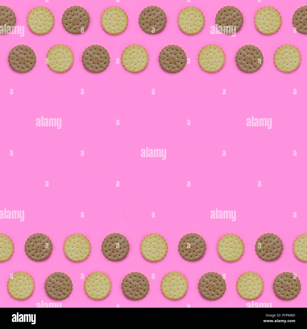 Frame of a brown biscuits on a pink background. Trendy minimal concept ...