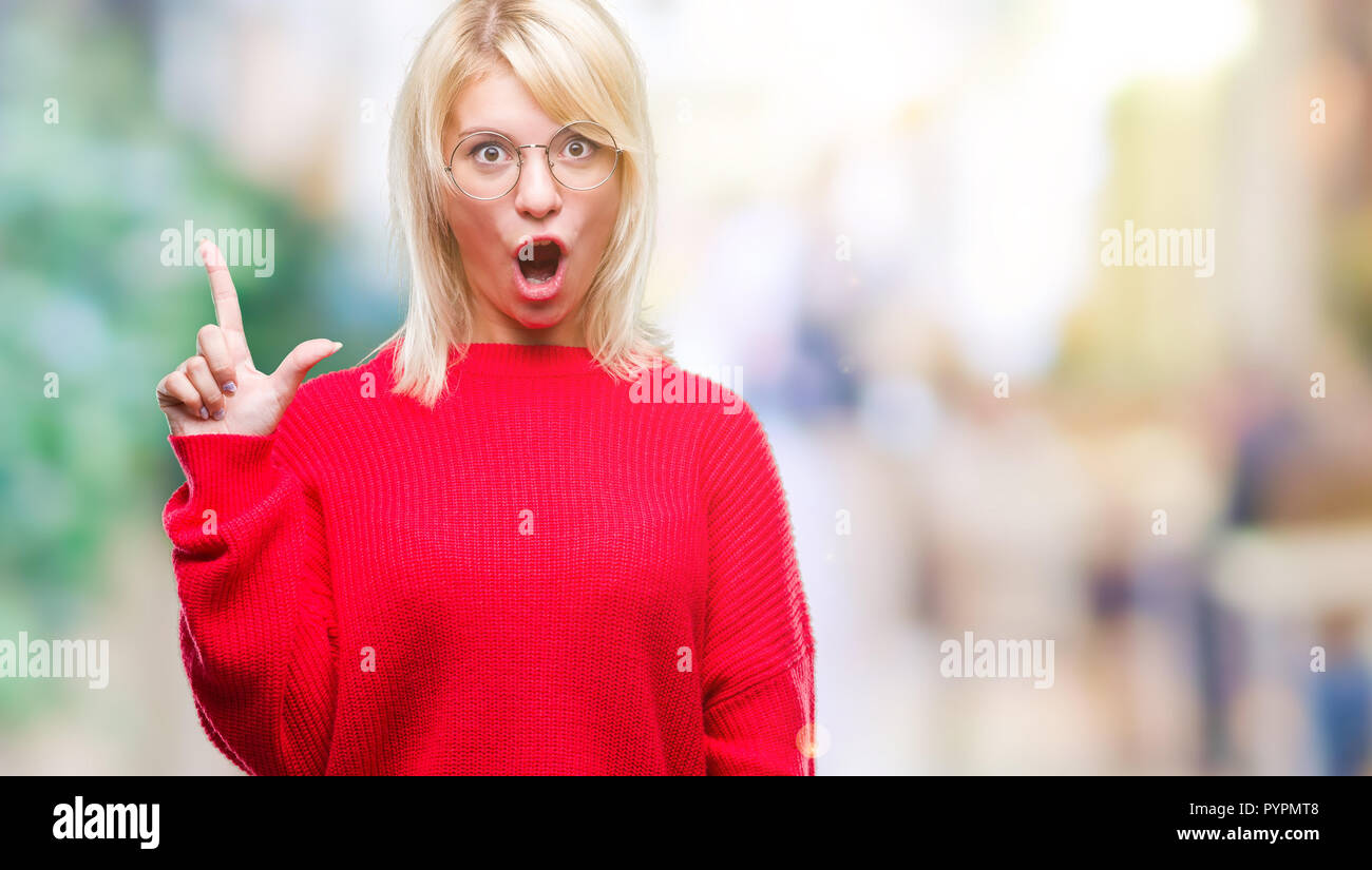 Young Beautiful Blonde Woman Wearing Sweater And Glasses Over Isolated