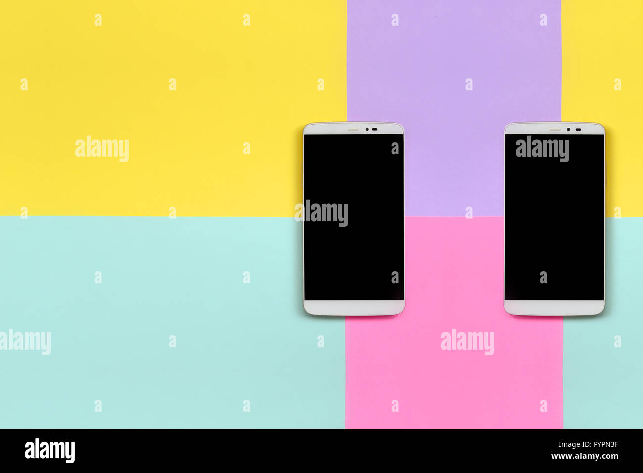 Two modern smartphones with black screens on texture background of ...