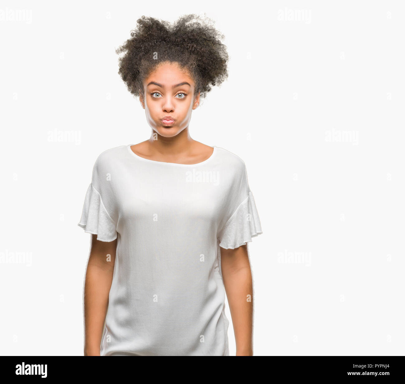 Young afro american woman over isolated background puffing cheeks with ...