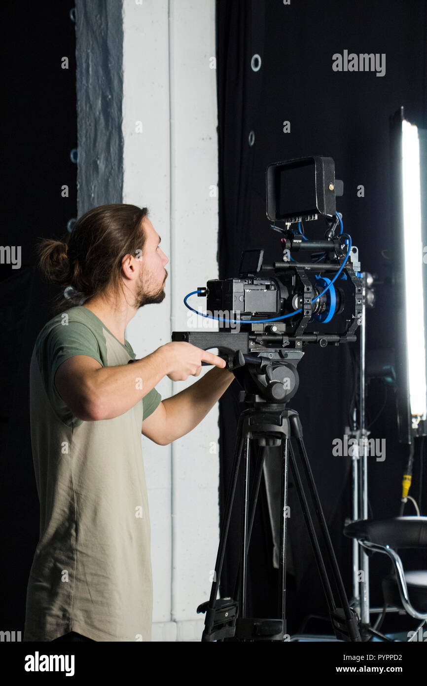 Professional videographer using cinema digital video camera which ...