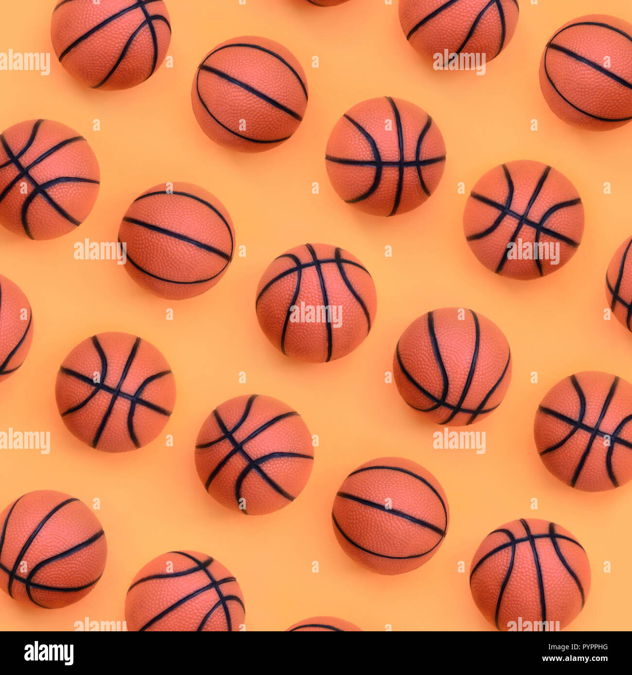 Many small orange balls for basketball sport game lies on texture ...