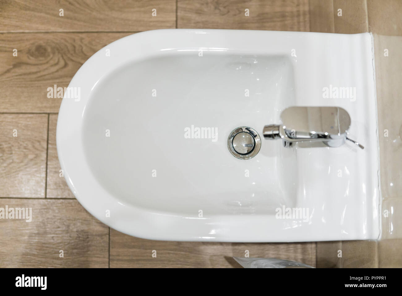 White ceramic bidet in modern bathroom. wc Stock Photo - Alamy
