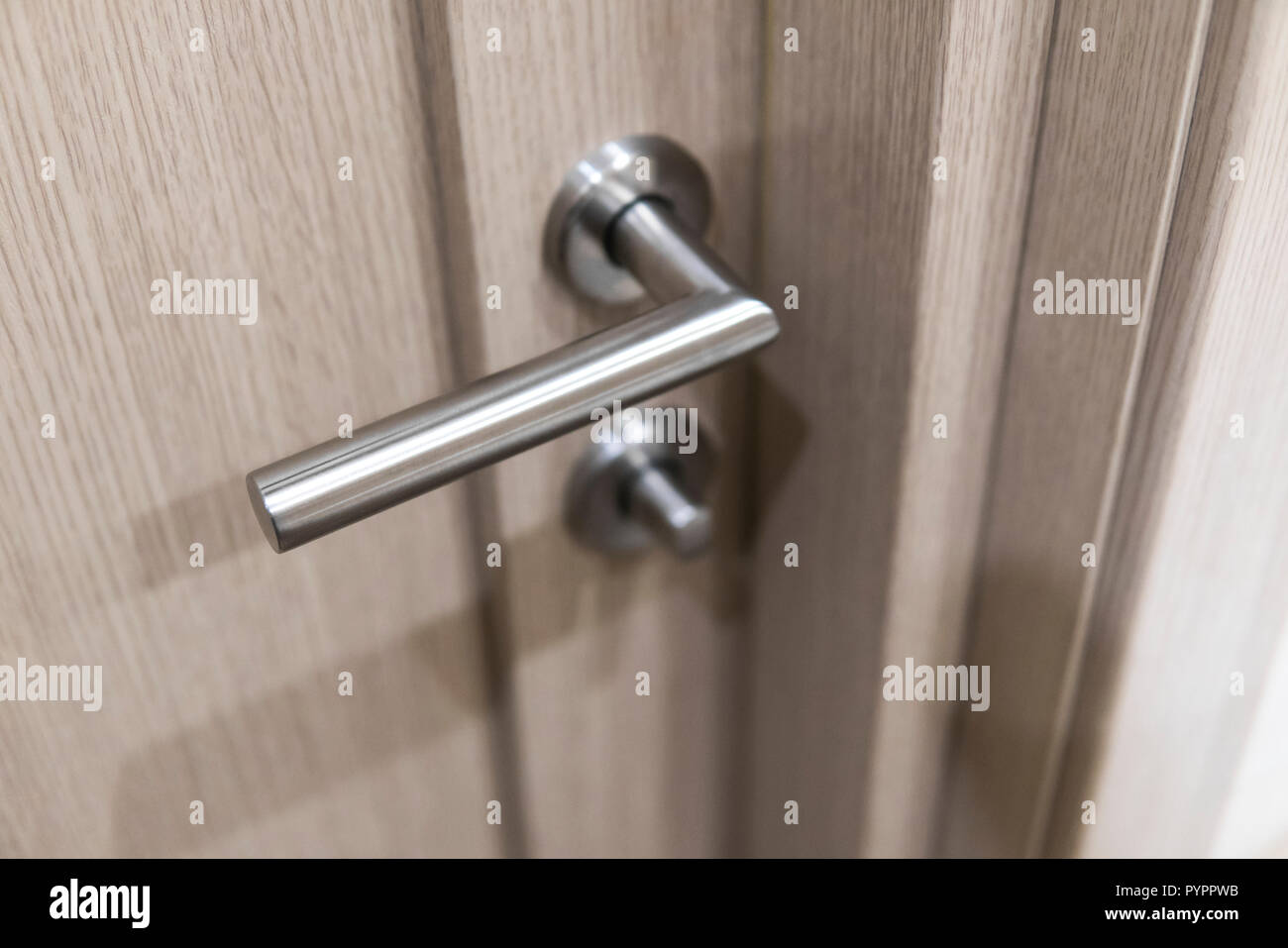 Detail of wooden door. Door handle close-up with blurred background ...