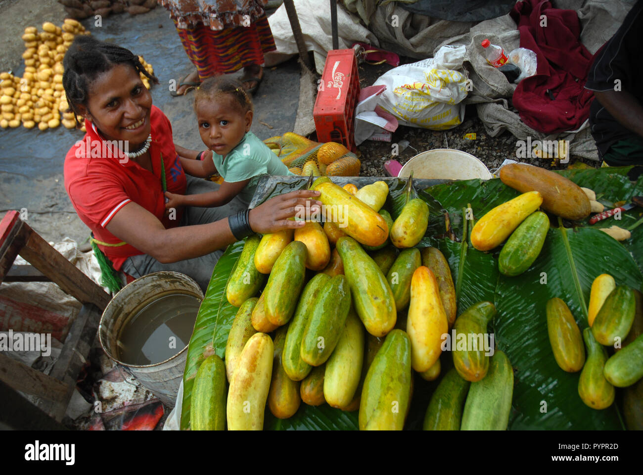 Lady and her son selling cucumbers at Boroko market, Port Moresby ...