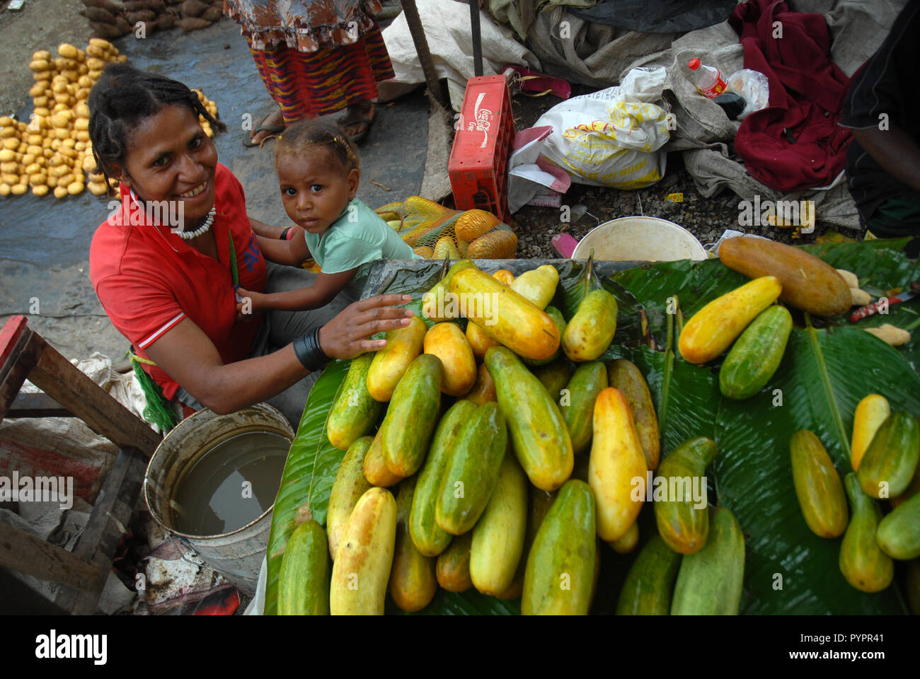 Lady and her son selling cucumbers at Boroko market, Port Moresby ...