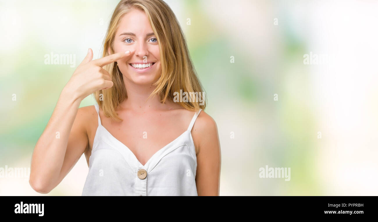Beautiful young woman over isolated background Pointing with hand ...