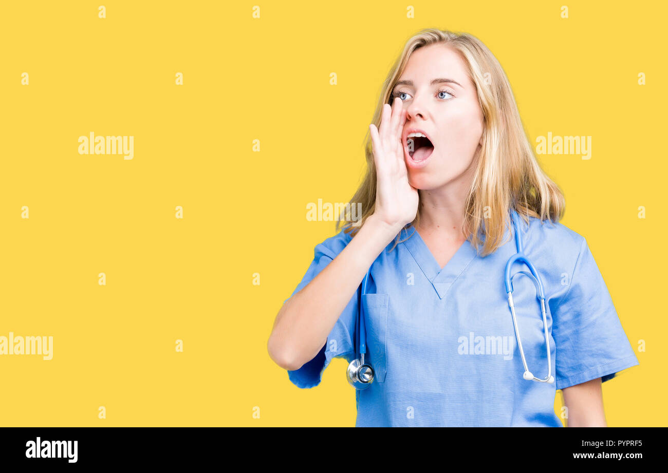 Beautiful young doctor woman wearing medical uniform over isolated ...