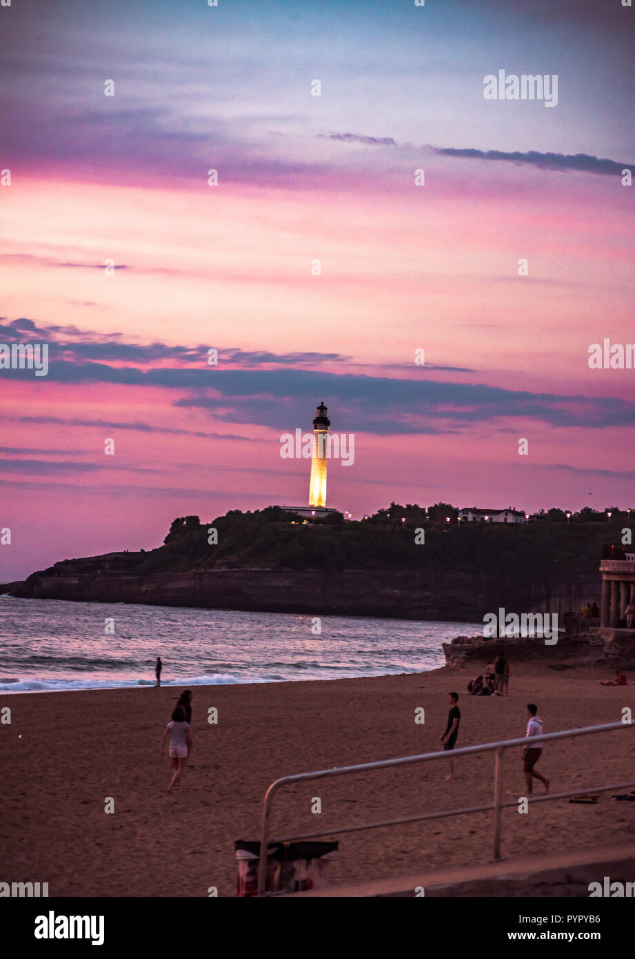 Biarritz , France . People enjoying a summer sunset on the beach called ...
