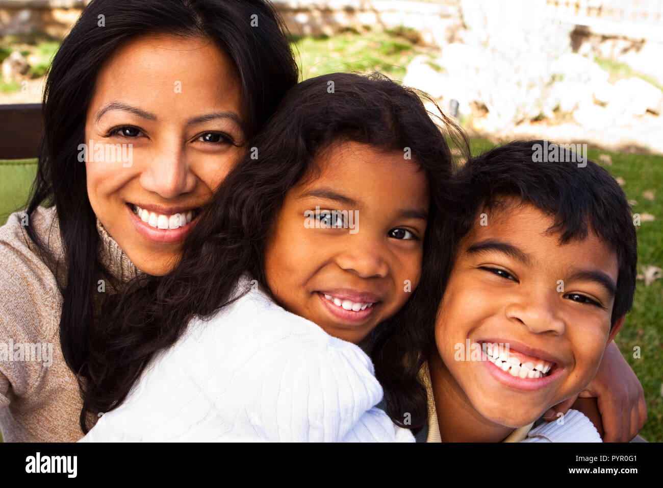 Biracial mother and her children laughing and smiling outside Stock ...