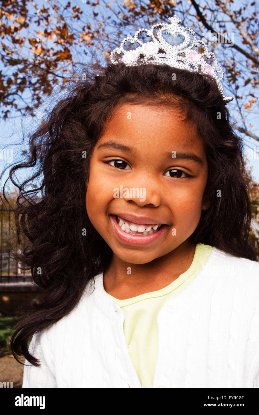 Cute little girl smiling wearing a tiara Stock Photo - Alamy