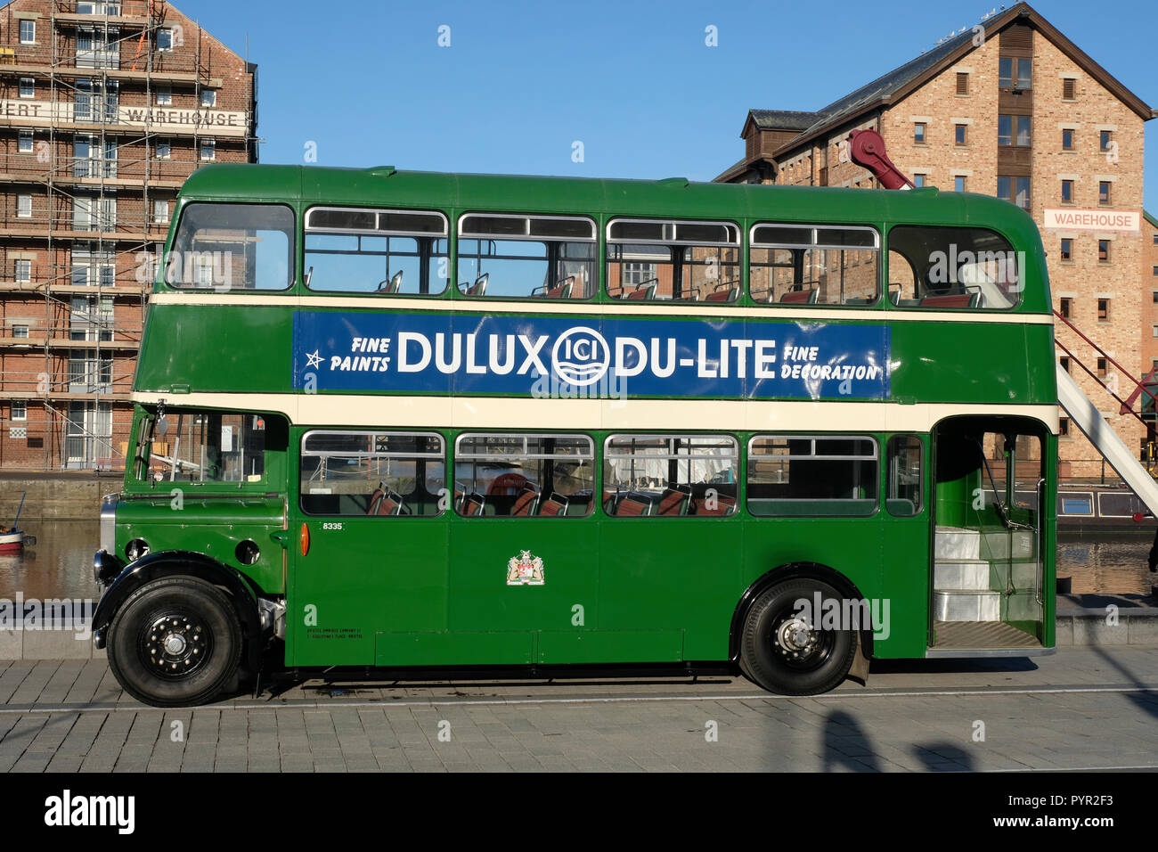 Green double-decker bus in a parade of classic motor vehicles at ...