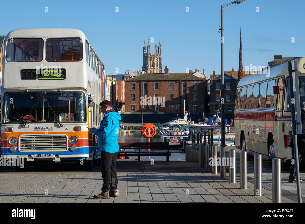 Classic buses in Gloucester docks framing the city's cathedral Stock ...