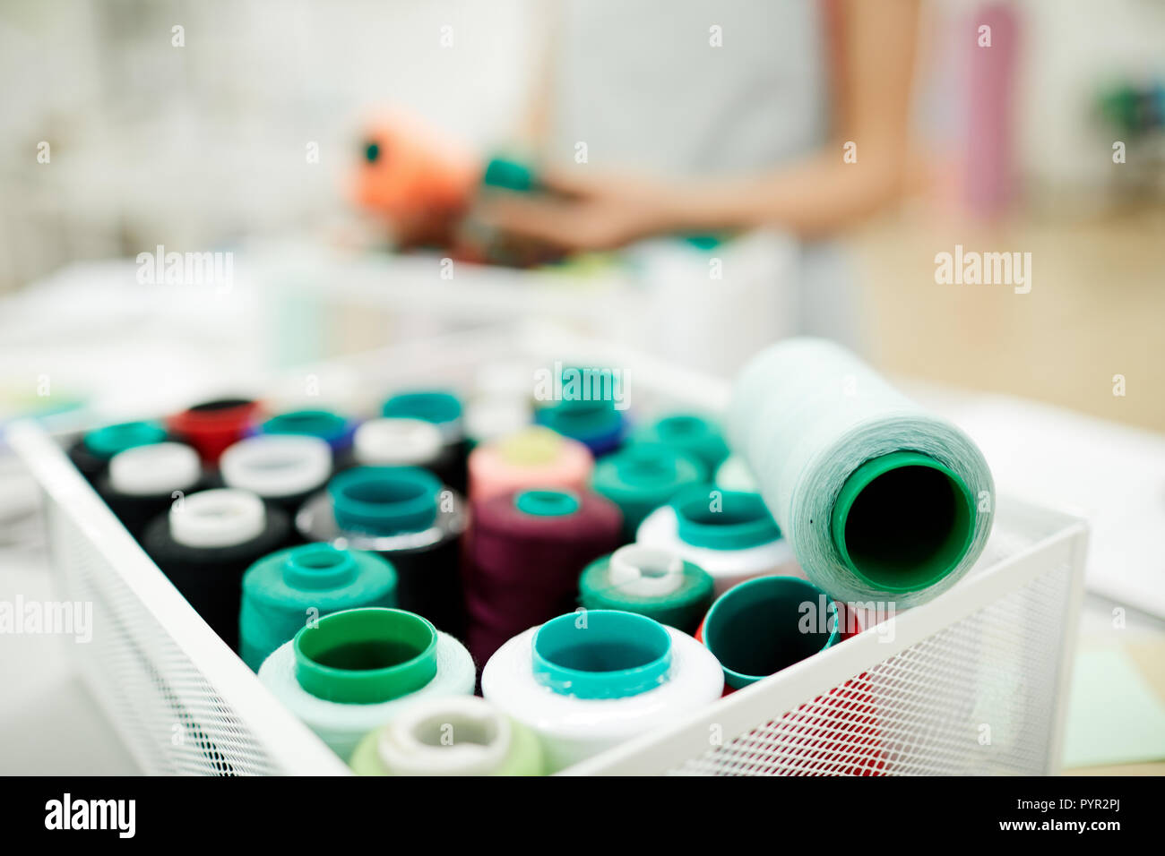 Container with colorful thread spools Stock Photo - Alamy