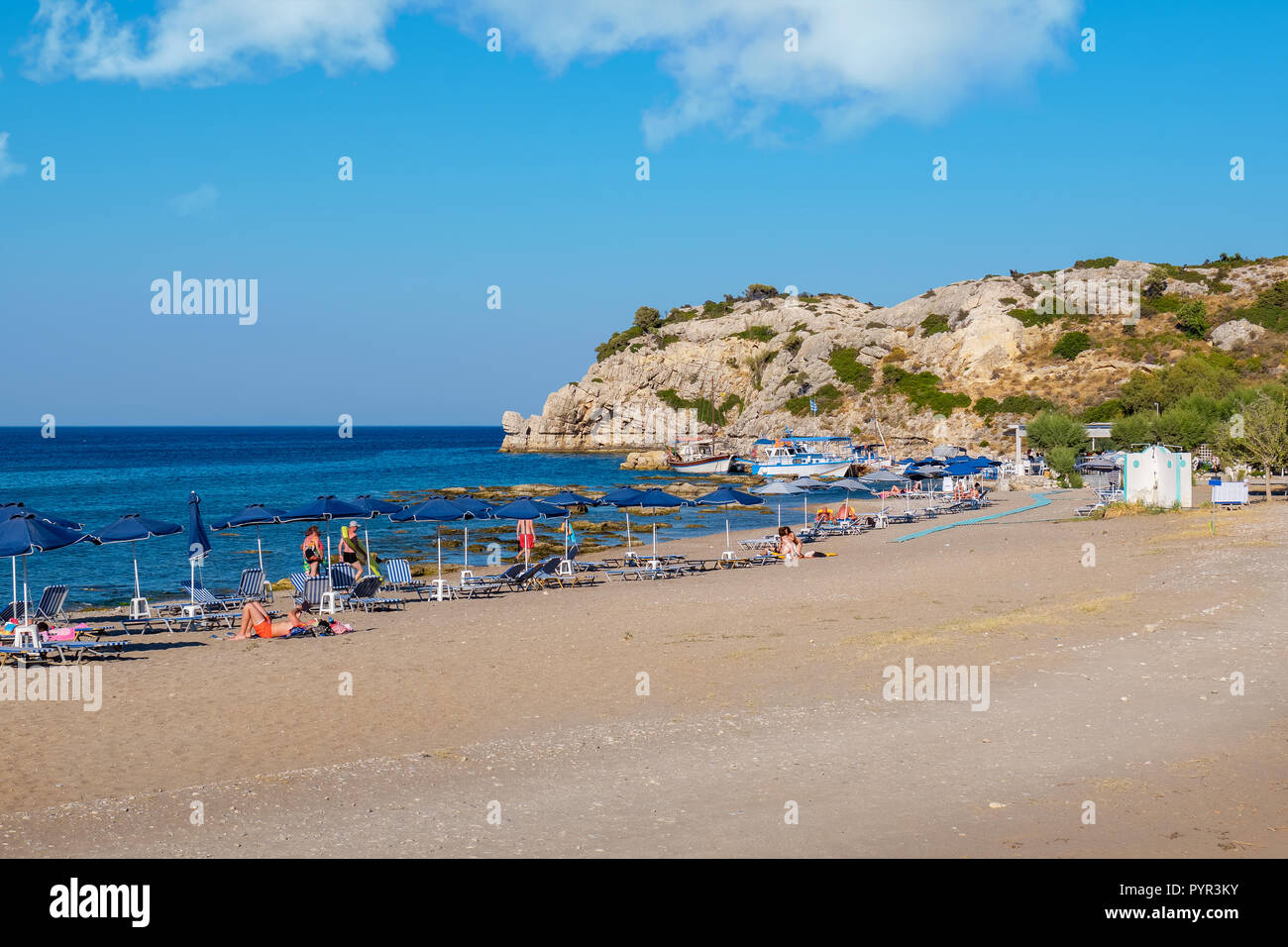 Sun beds and umbrellas on sandy Kolymbia beach. Rhodes Island, Greece ...