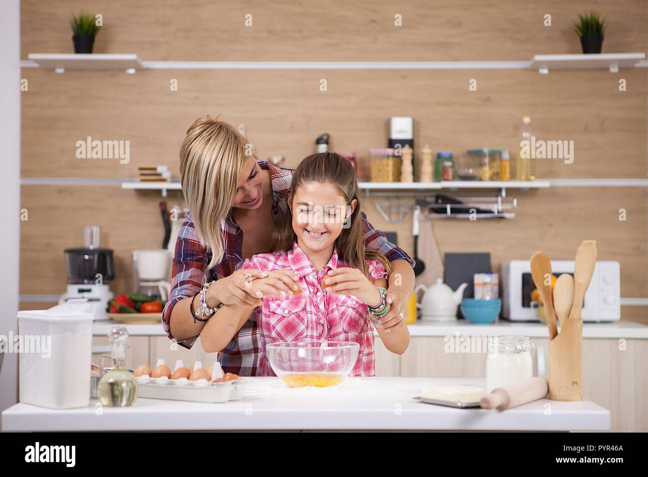Portrait of happy mother and daughter smiling while cooking. Healthy ...