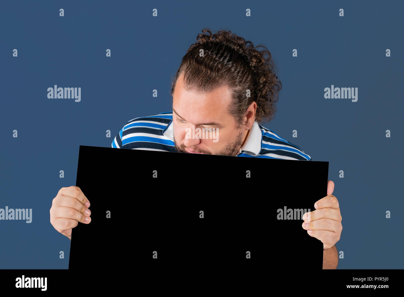 Fat funny man holding a black writing board Stock Photo - Alamy