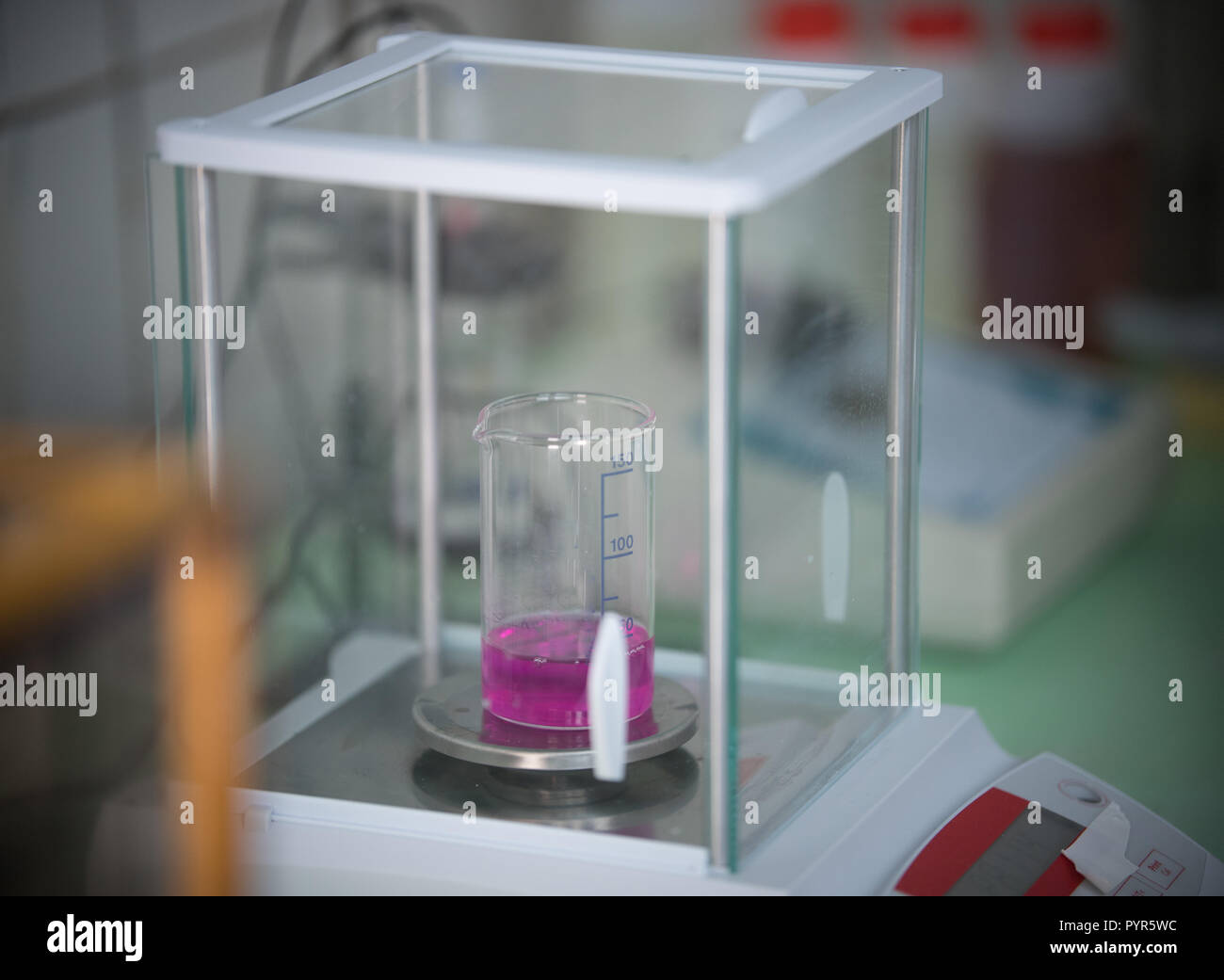 Chemical laboratory. Weighting liquid in the flask Stock Photo - Alamy