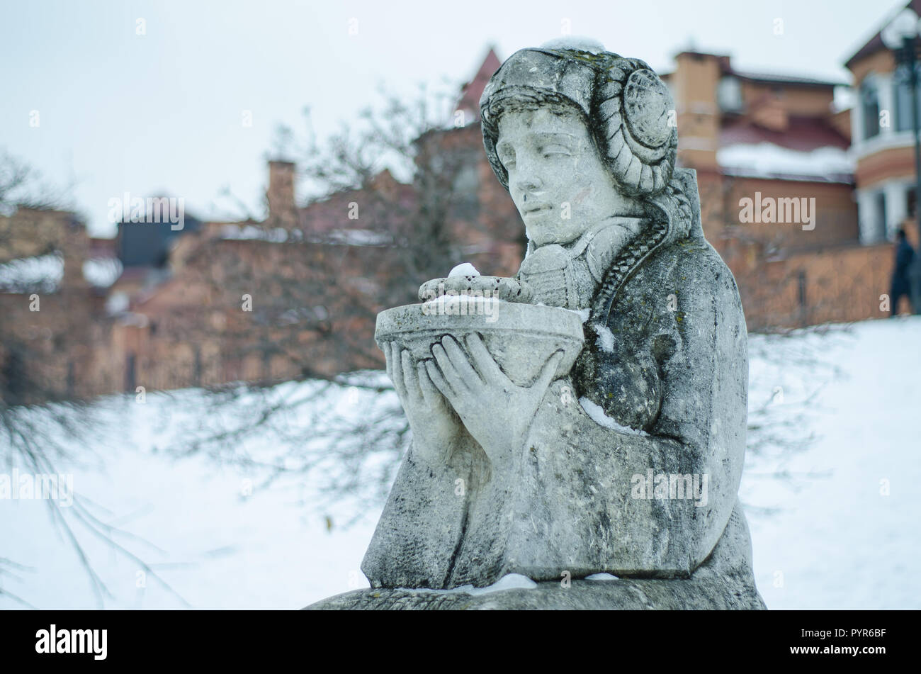 Statue in winter under the snow. City details Stock Photo - Alamy