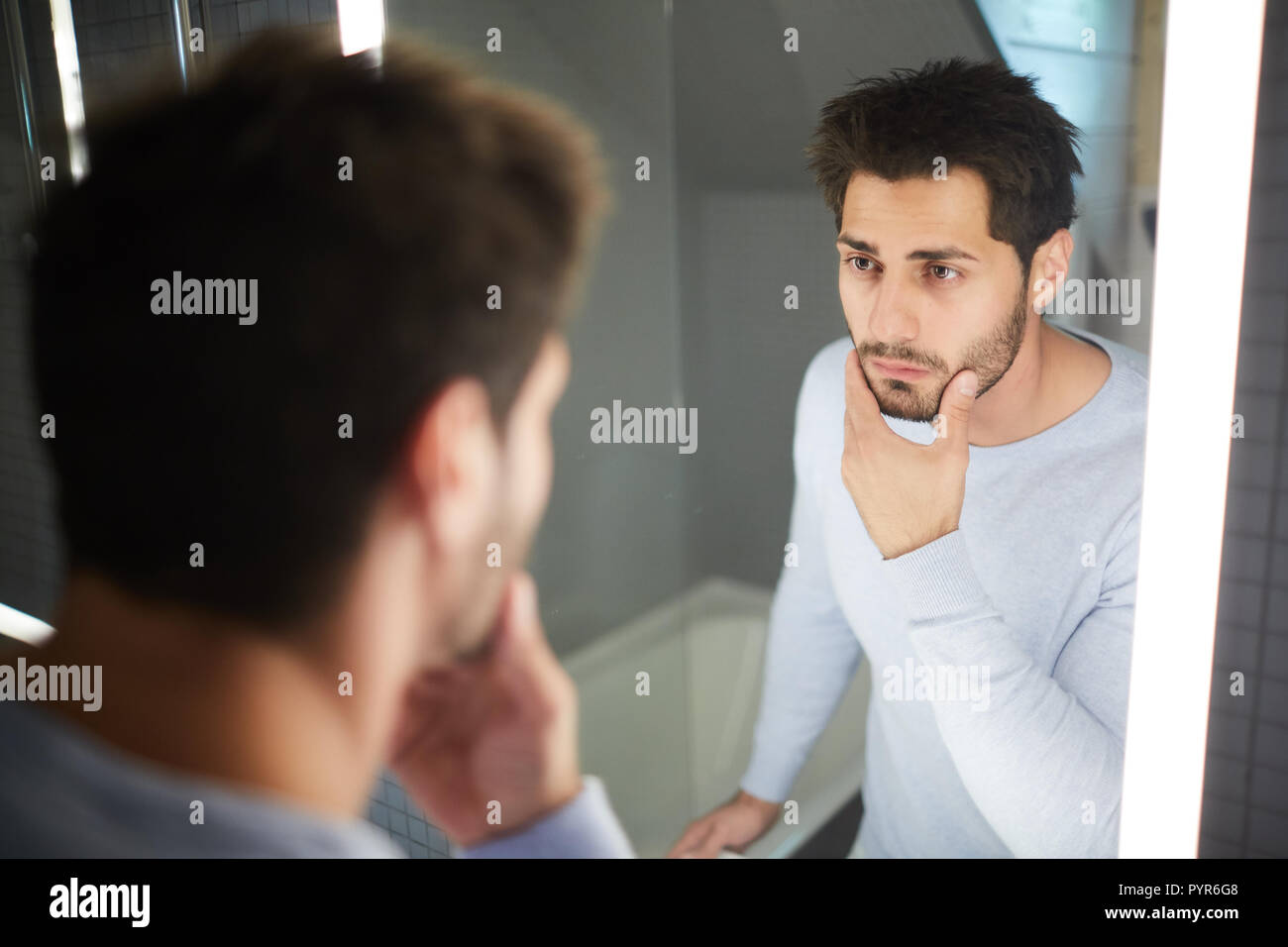 Guy looking at mirror hi-res stock photography and images - Alamy