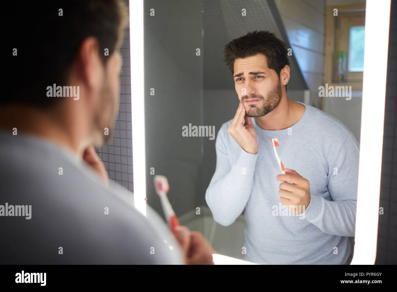 Sad man getting bad tooth Stock Photo - Alamy