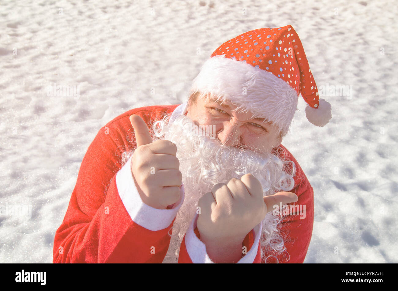 Funny fat man dressed as santa claus is sitting on the snow Stock Photo ...