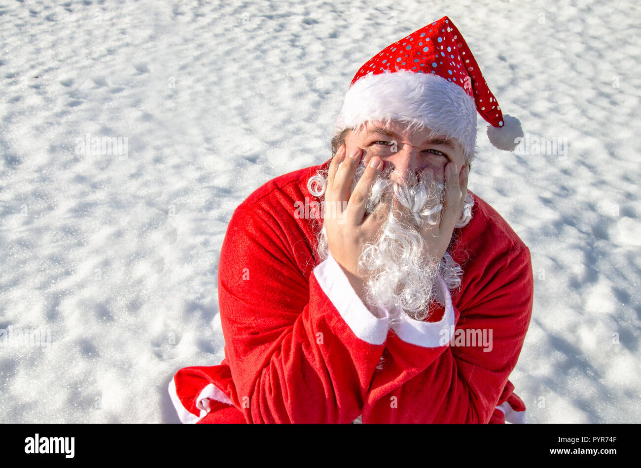 Funny fat man dressed as santa claus is sitting on the snow Stock Photo ...