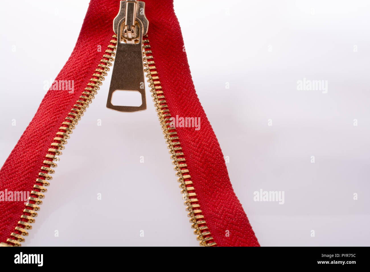 Hand holding color zipper on a white background Stock Photo - Alamy